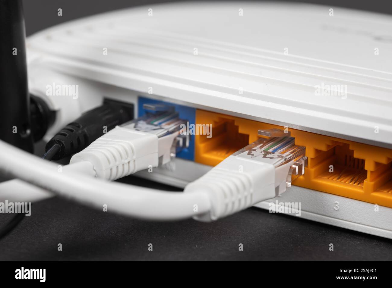 Connect an Ethernet Cable to a Wireless Router on dark. Ethernet, rj45 ...