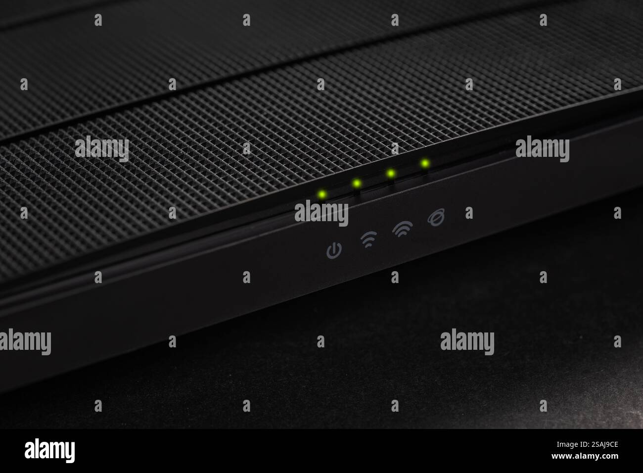 new black wifi router with green light on in office Stock Photo - Alamy