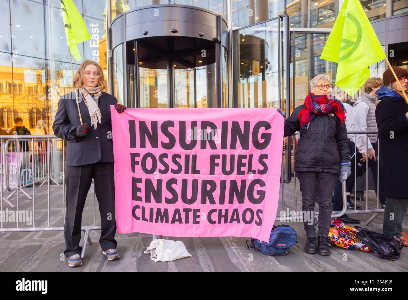 London, UK. 30 JAN, 2025. Protestors hold sign "Insuring Fossil Fuels ...