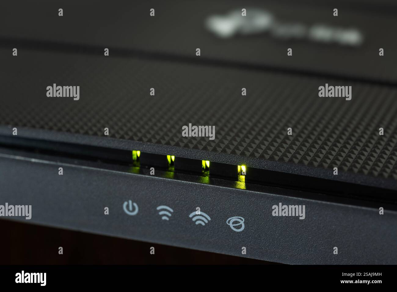 new black wifi router with green light on in office Stock Photo - Alamy