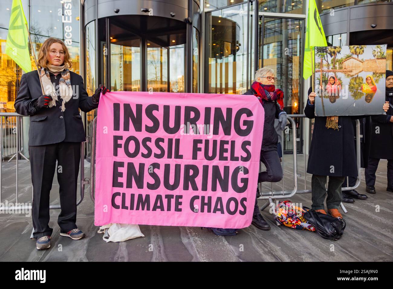 London, UK. 30 JAN, 2025. Protestors hold sign "Insuring Fossil Fuels ...