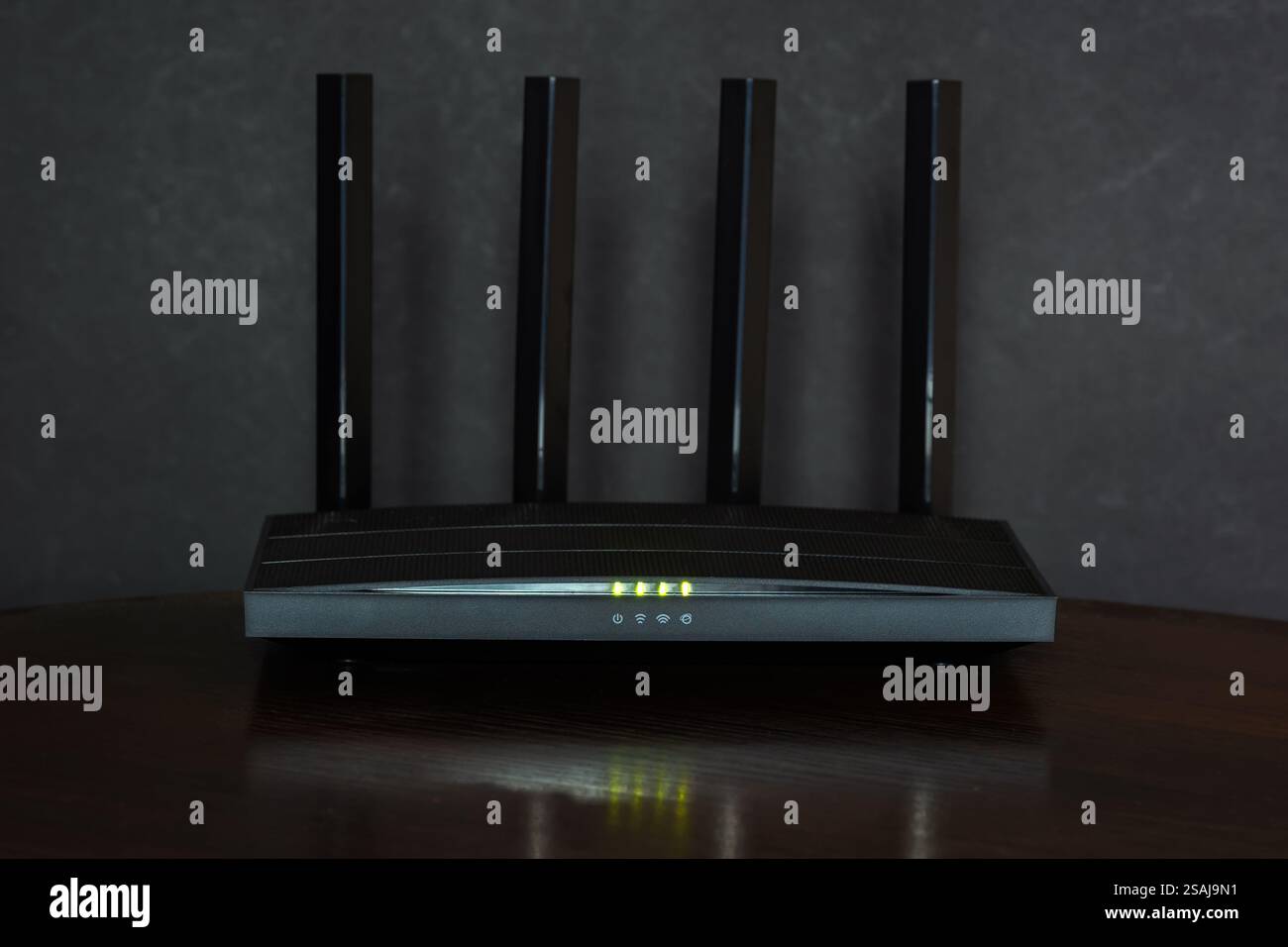 Wi-Fi router on black wooden table in room Stock Photo - Alamy