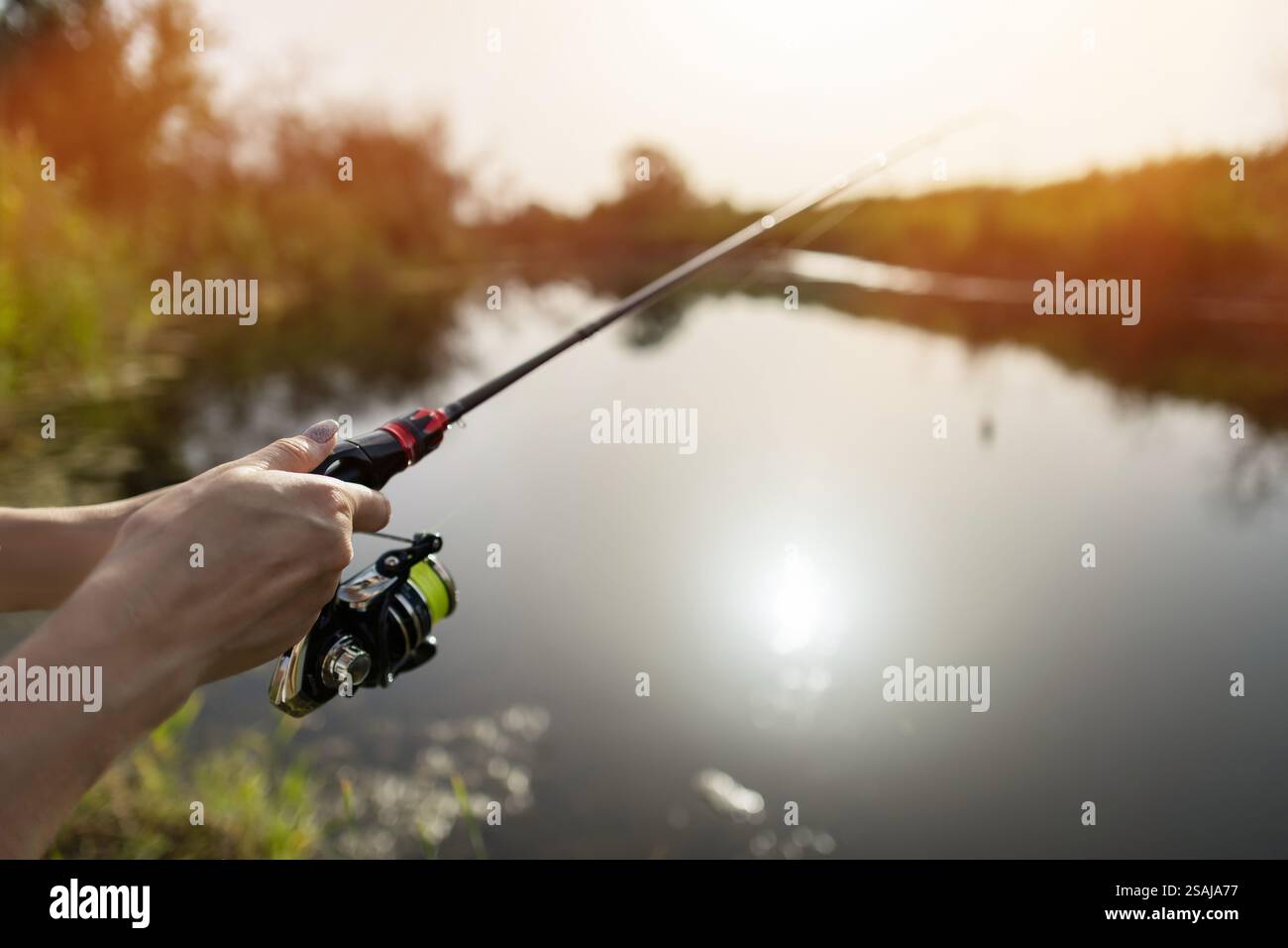 Hands holding a fishing rod hi-res stock photography and images - Alamy