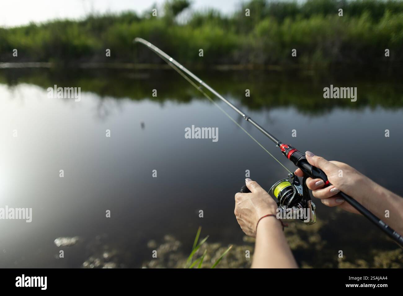Hands holding a fishing rod hi-res stock photography and images - Alamy