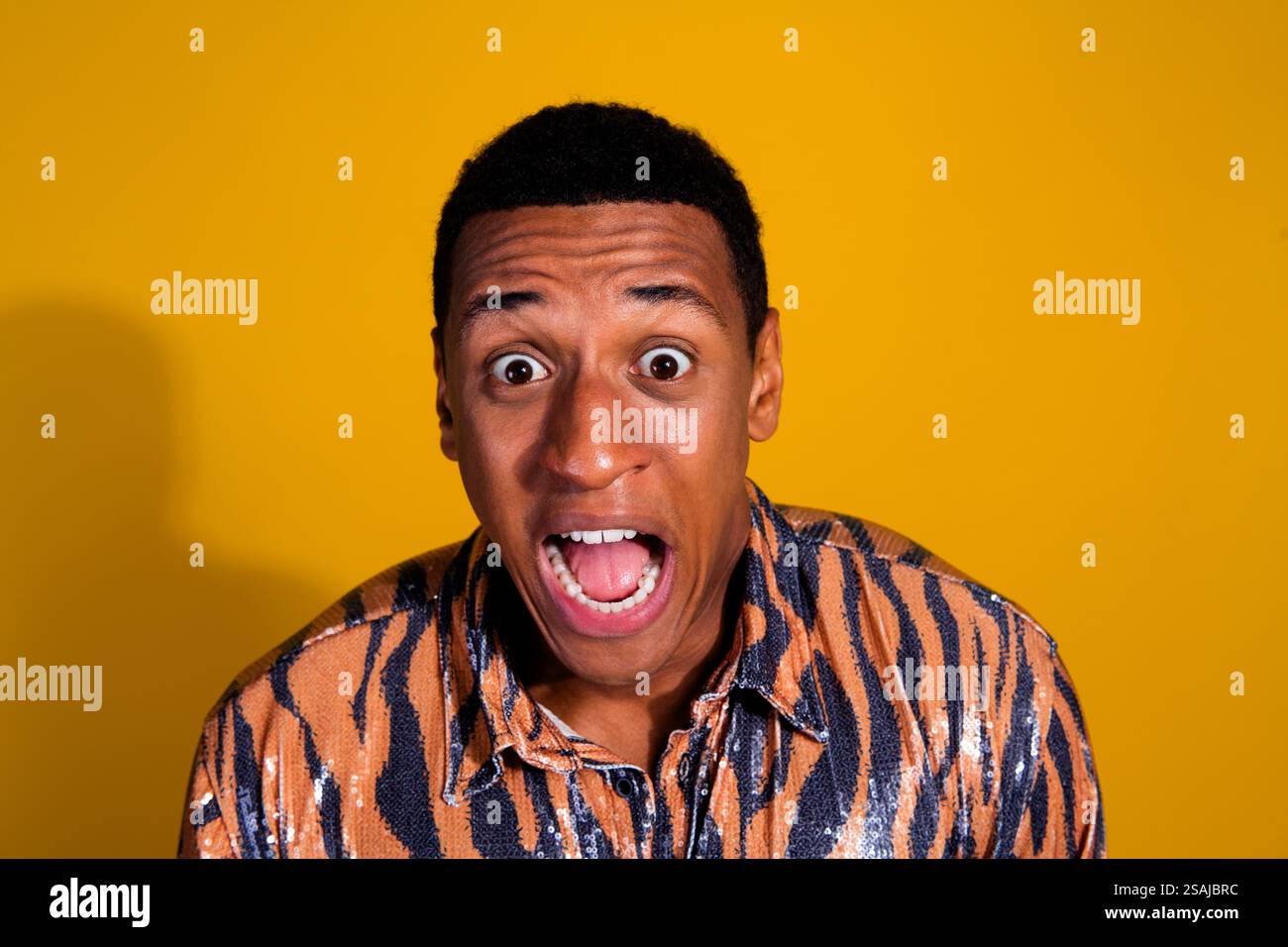 Young stylish man expressing surprise with comic facial expression ...