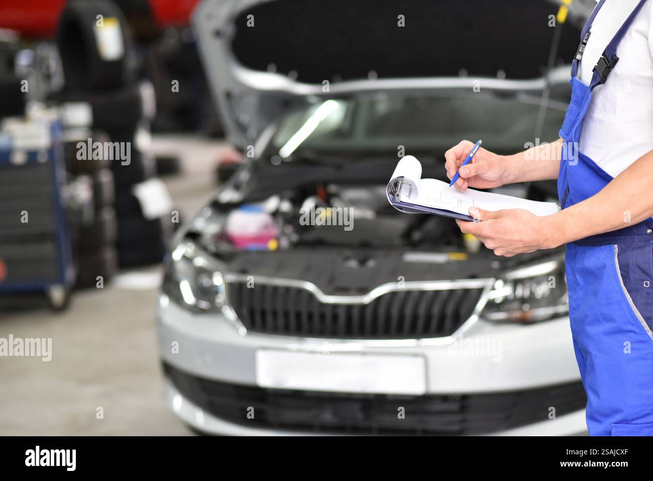 car mechanic works in a workshop, repair of cars Stock Photo - Alamy