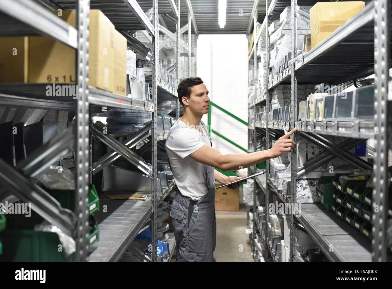 employees of a car repair shop in a warehouse for spare parts Stock ...