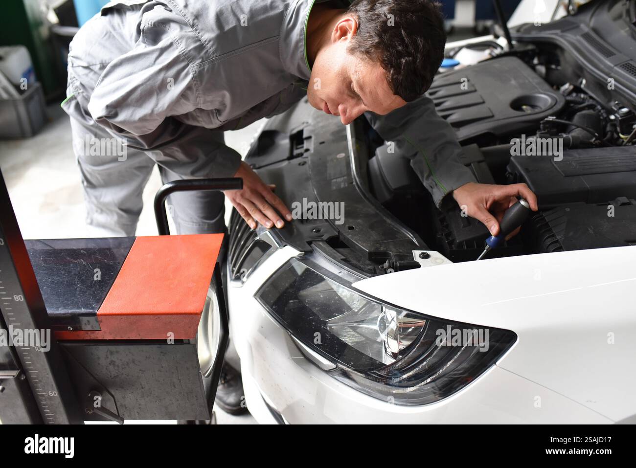 car mechanic in a workshop - engine repair and diagnosis on a vehicle ...