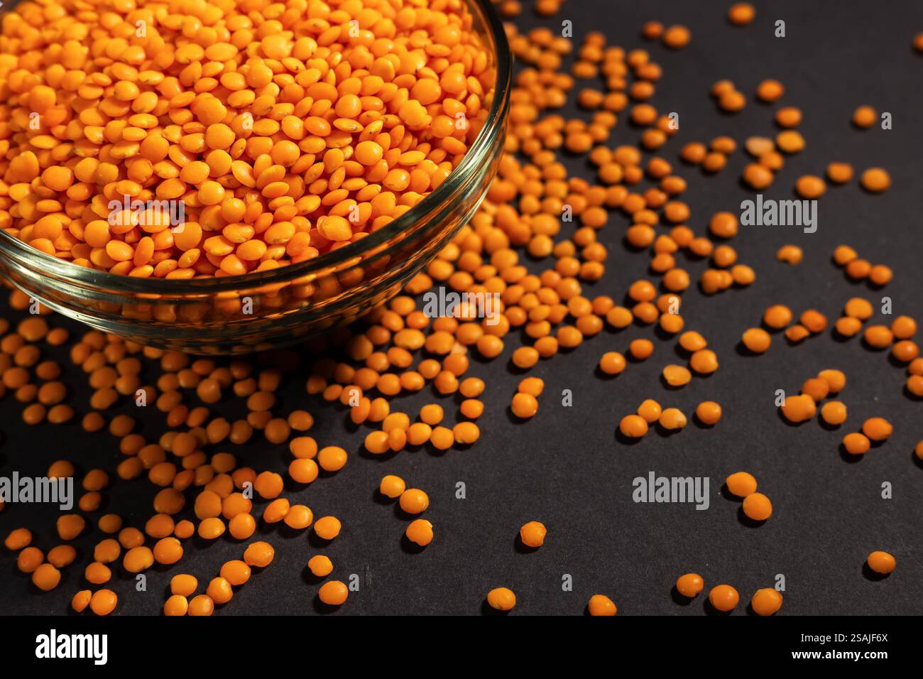 Red lentils in glass bowl. Dry orange lentil grains, heap of dal, raw ...