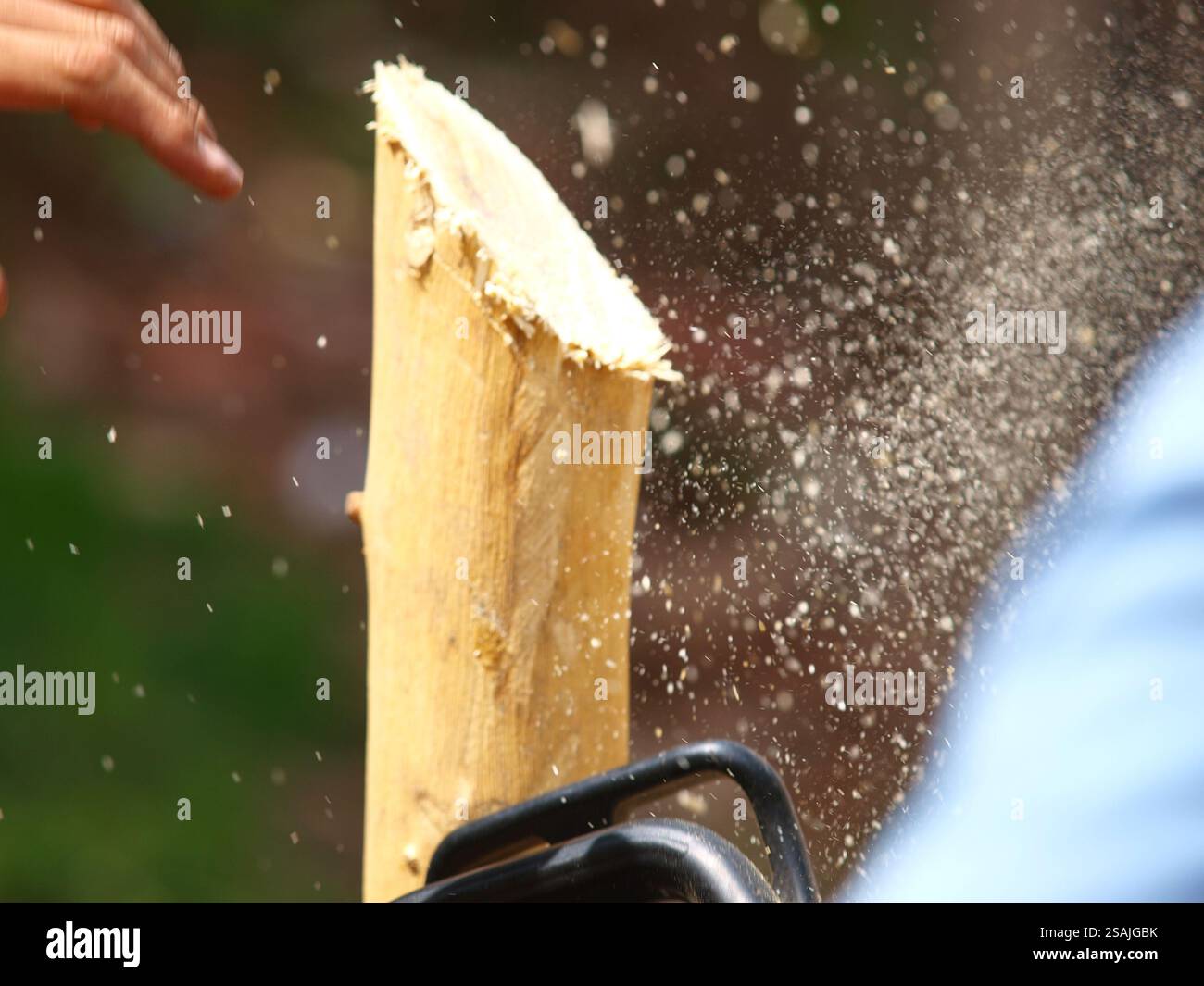 Close-Up Of A Worker Using A Chainsaw To Cut Wood: A Powerful Action ...