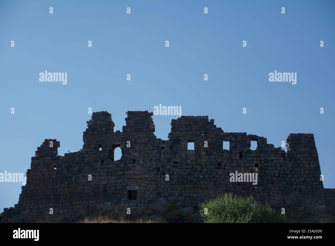 Old castle wall ruins. Caste window and church. Ruins of castle ...