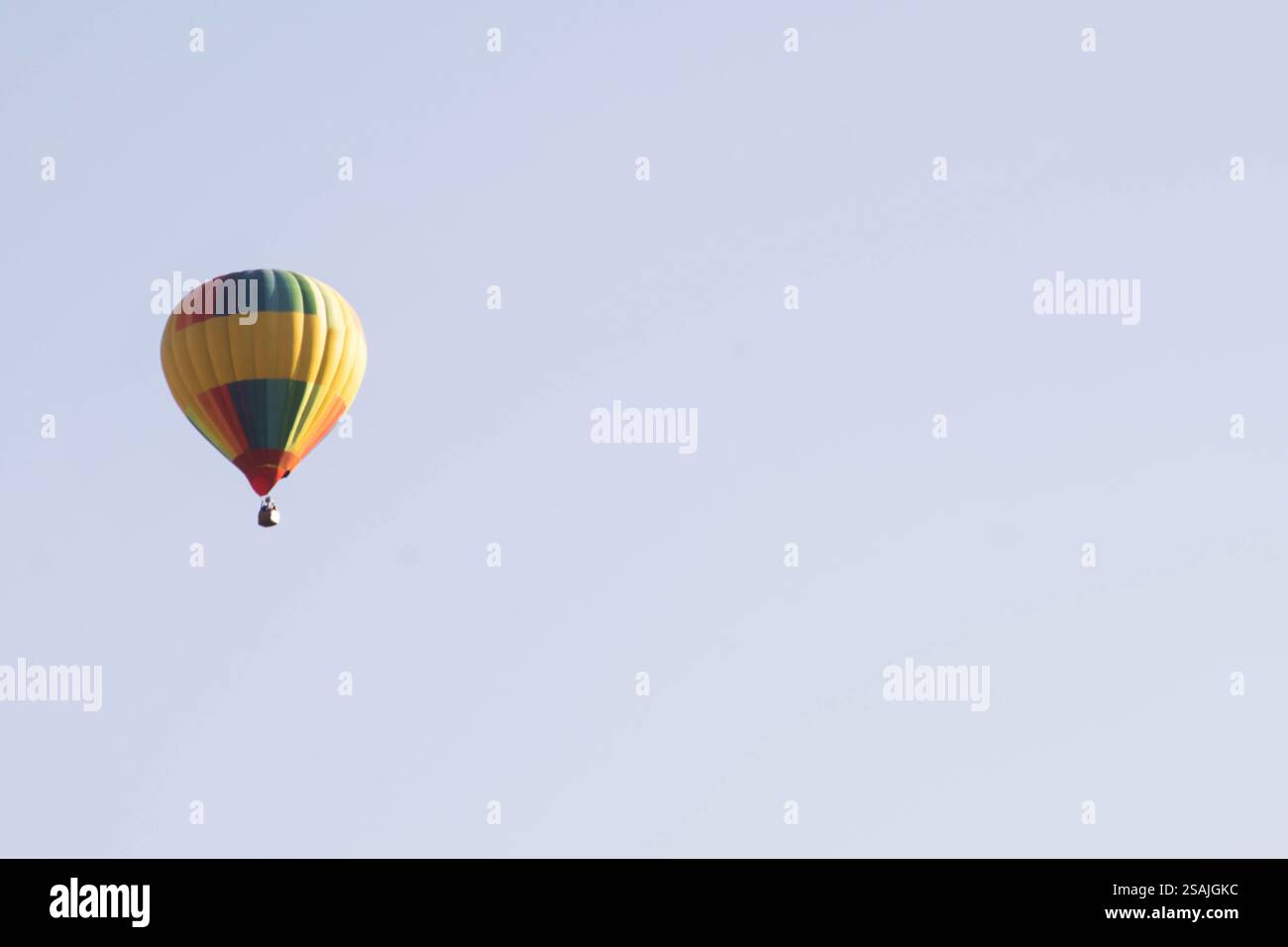 Colorful hot air balloon soaring in a clear blue sky during a sunny day ...