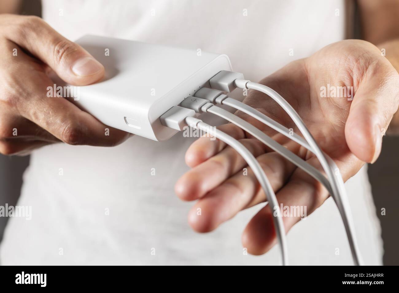 Hand holding powerbank with cable. Power saving device power bank Stock ...