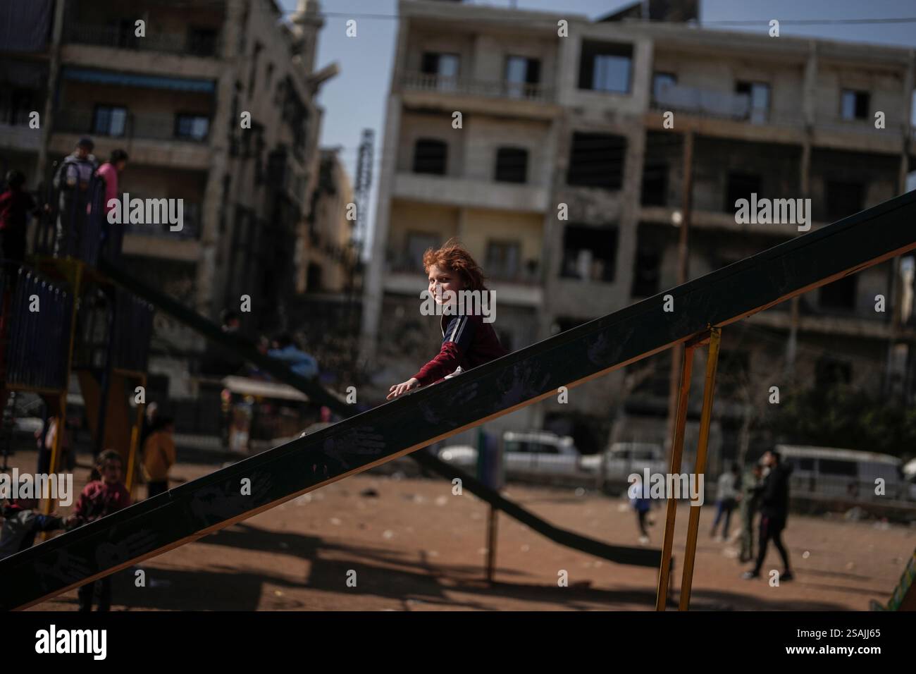A girl plays in a public park in Aleppo city, Syria, Thursday, Jan. 30 ...
