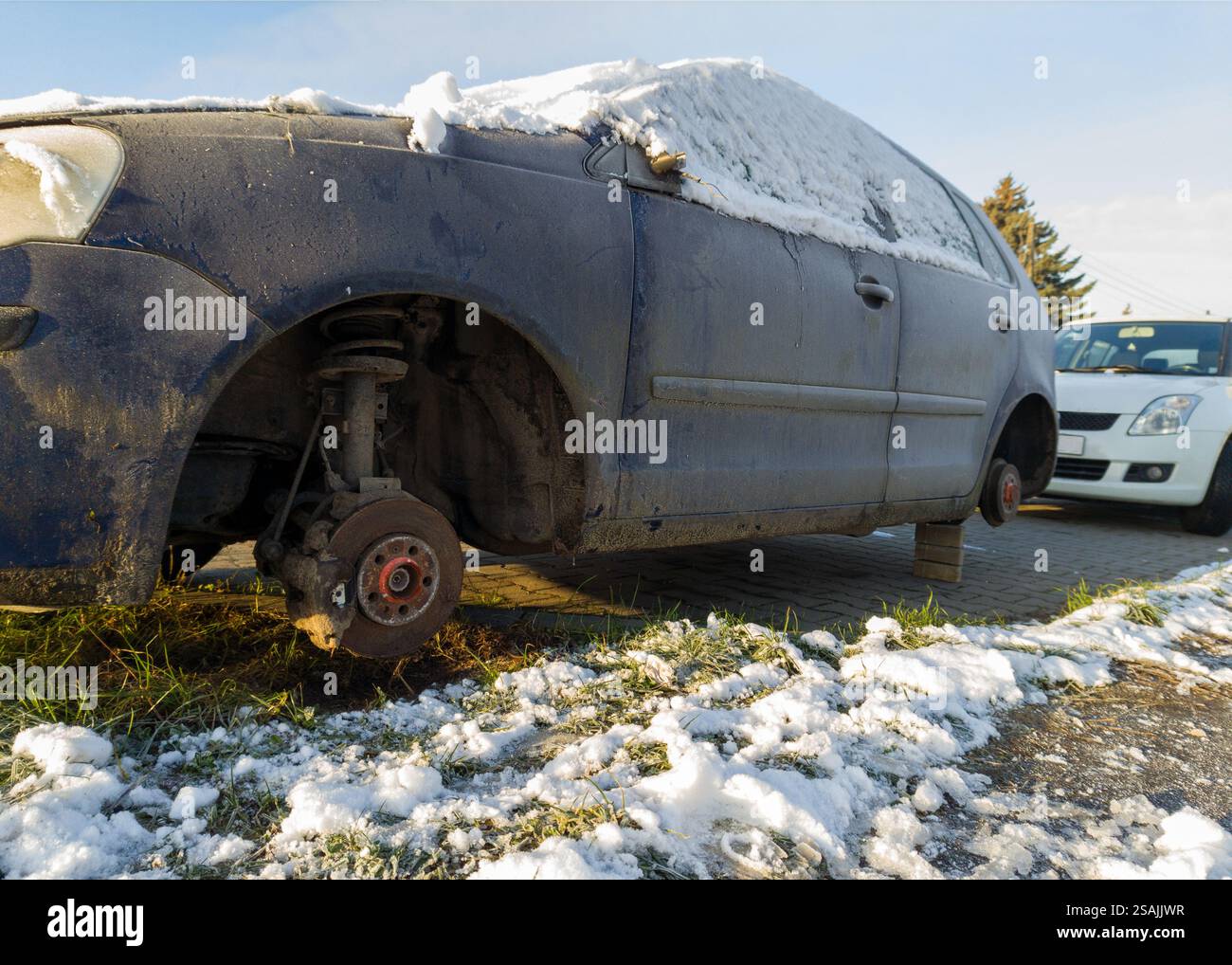 Abandoned Car on Blocks in Urban Area Stock Photo - Alamy