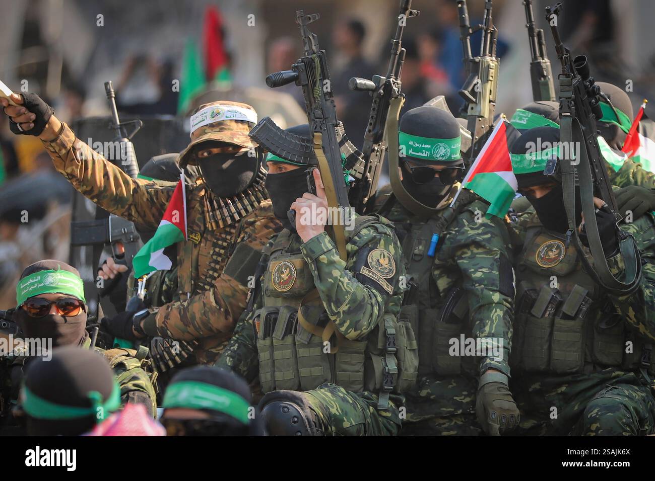 Hamas fighters arrive in a pick-up truck to the site of the hand over ...