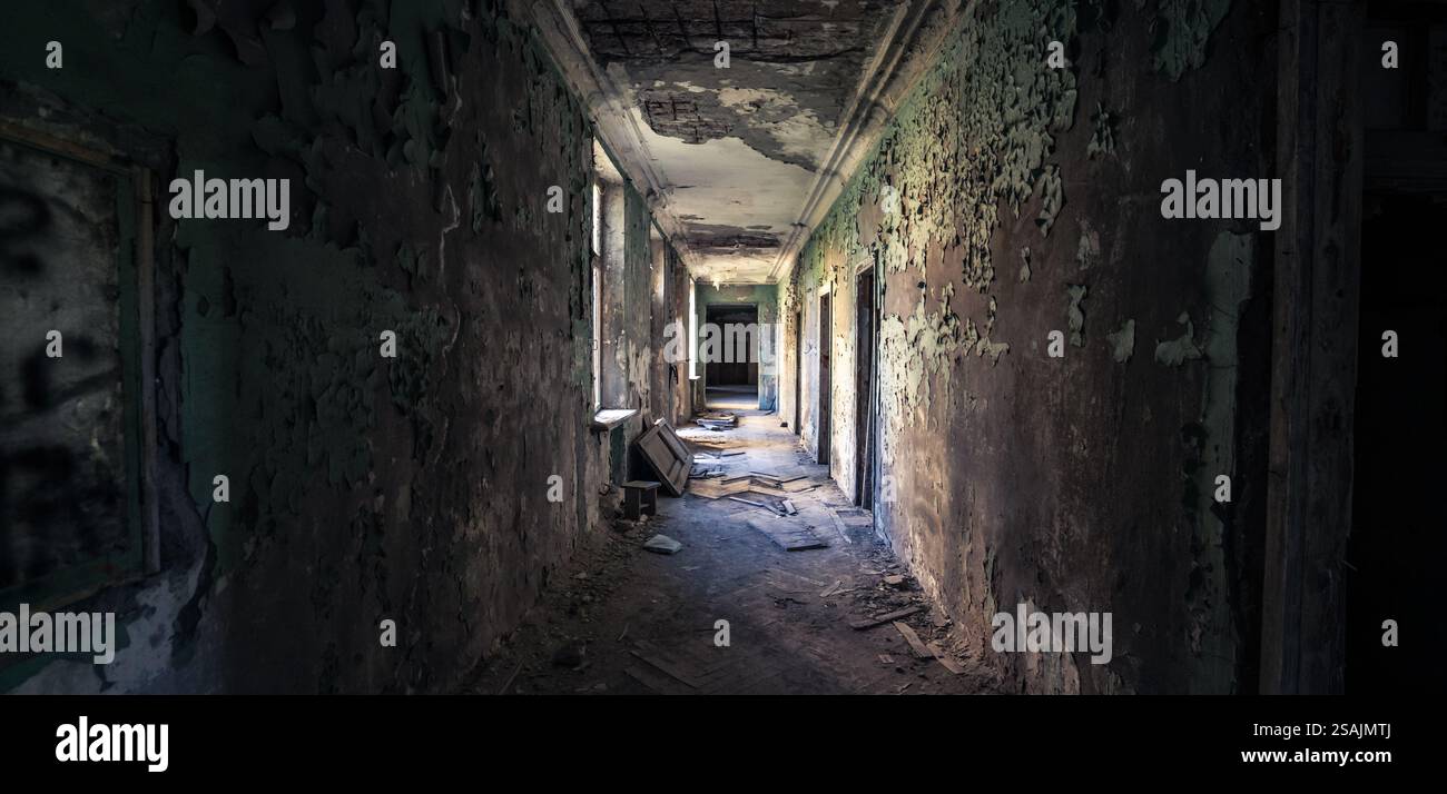 Long derelict corridor with crumbling walls and light flooding from ...