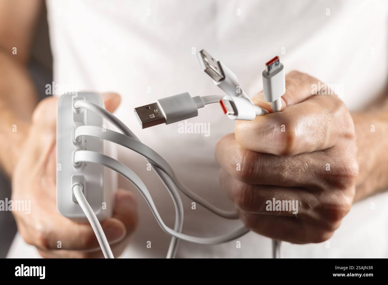 white power bankwith cable in hand. save energy and reduce energy ...