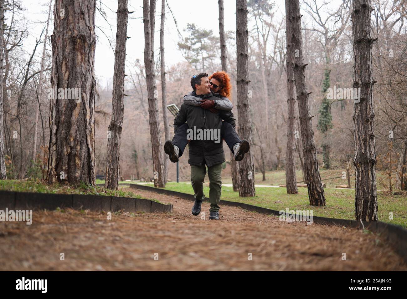 Adult man carrying his partner on his back Stock Photo - Alamy