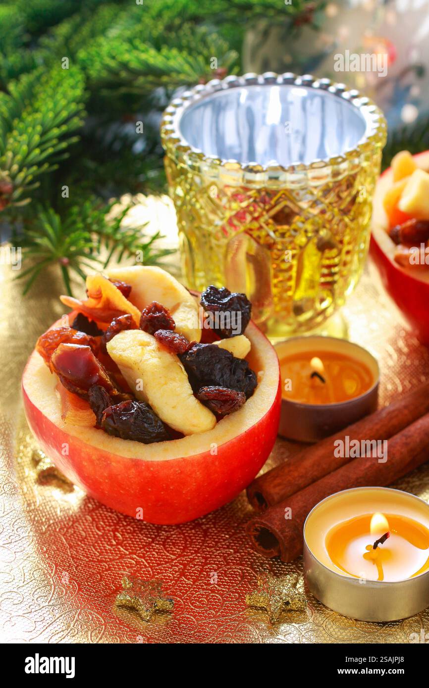 Red christmas apples stuffed with dried fruits in honey. Party dessert ...