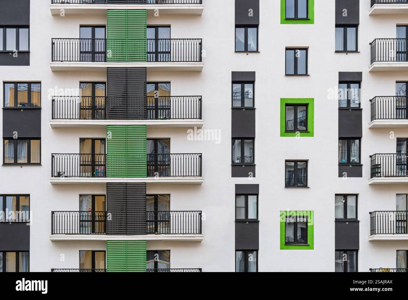 Modern apartment buildings with white facades and green accents ...