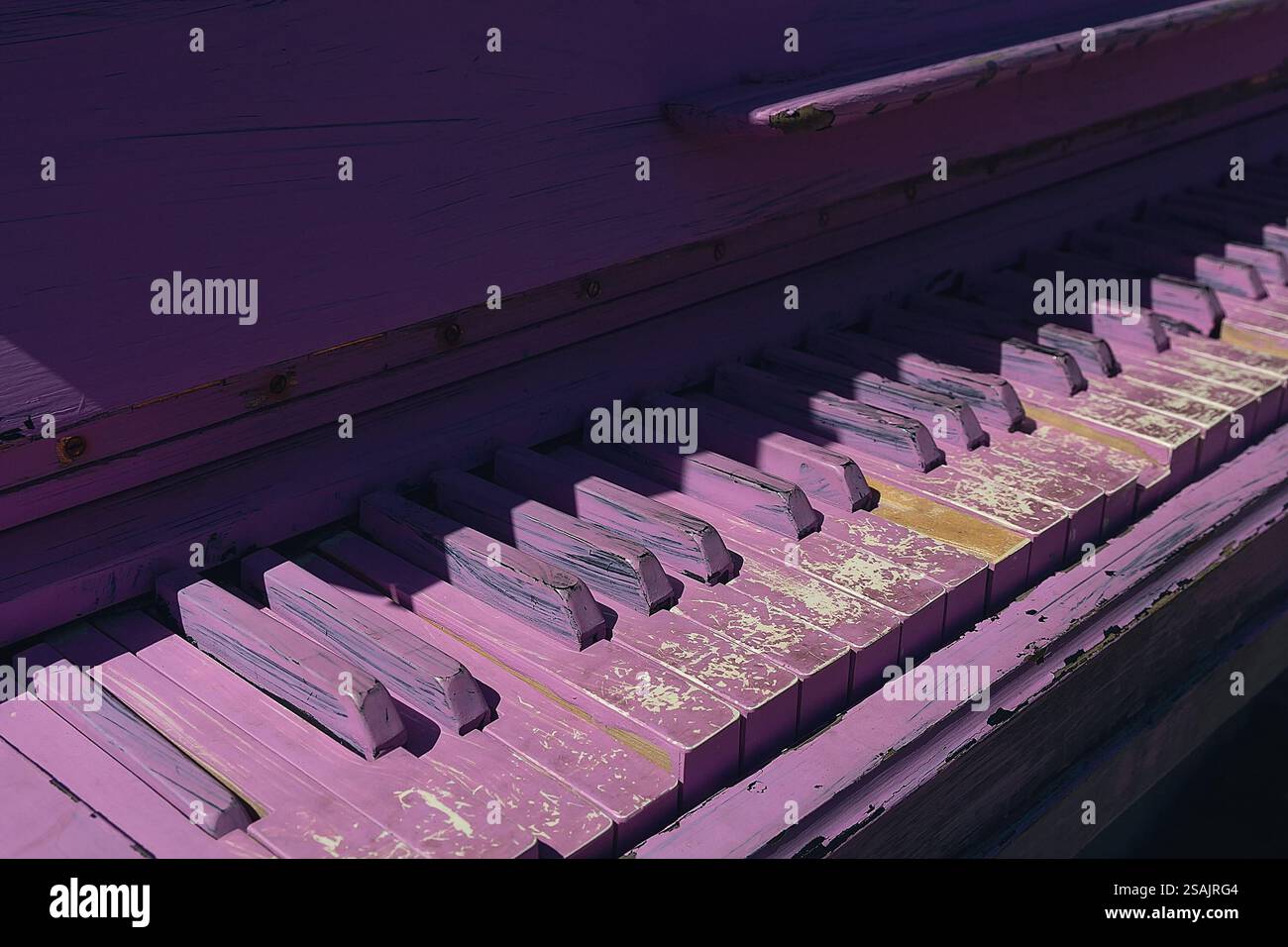 Old vintage grand piano keys painted purple close-up Stock Photo - Alamy