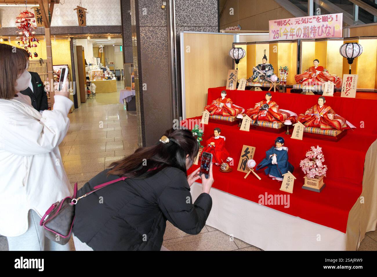 Tokyo, Japan. 30th Jan, 2025. Visitors take photos of unique Hina dolls ...