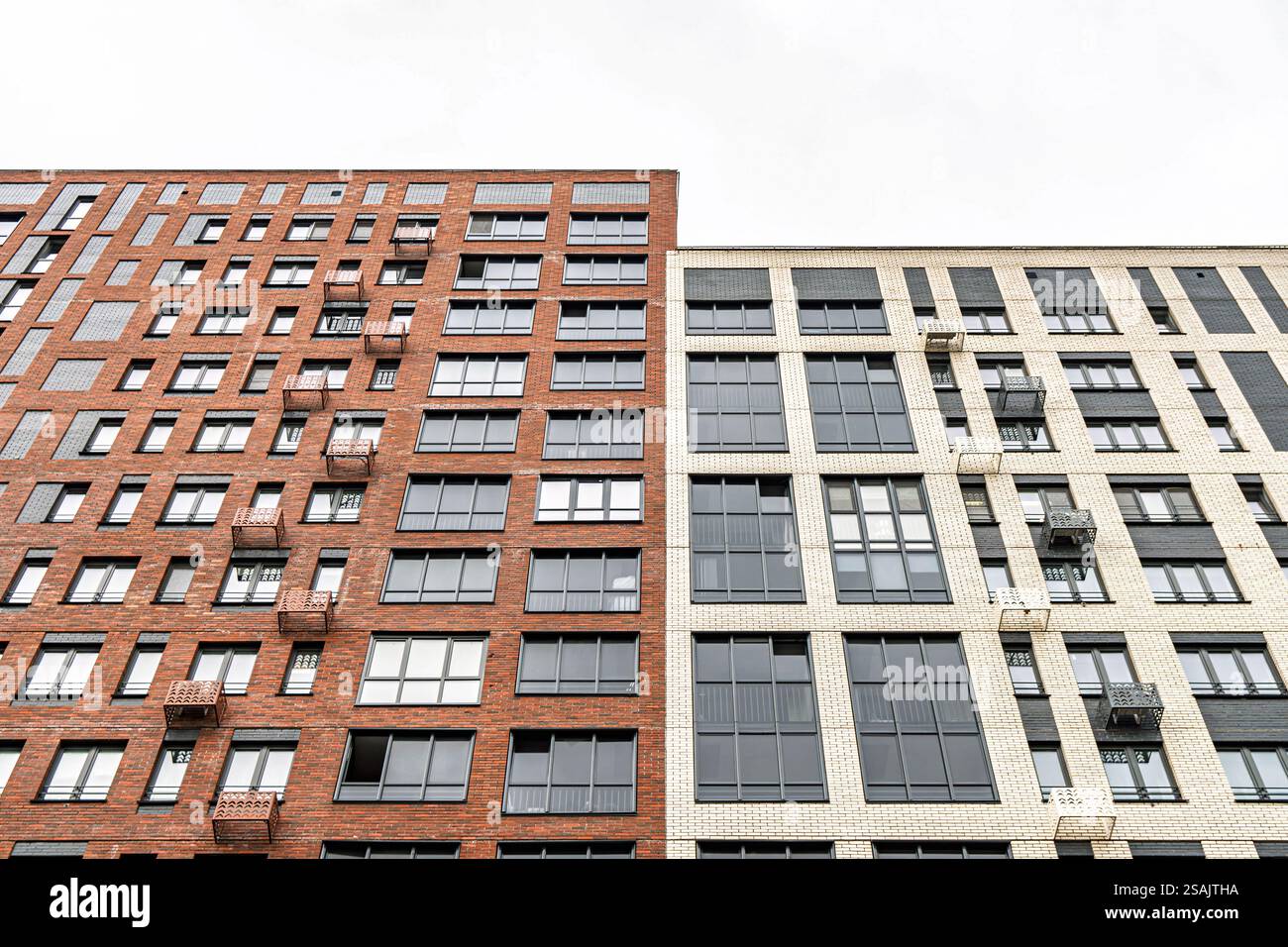 Contemporary multi-story buildings with beige, red brick and glass ...
