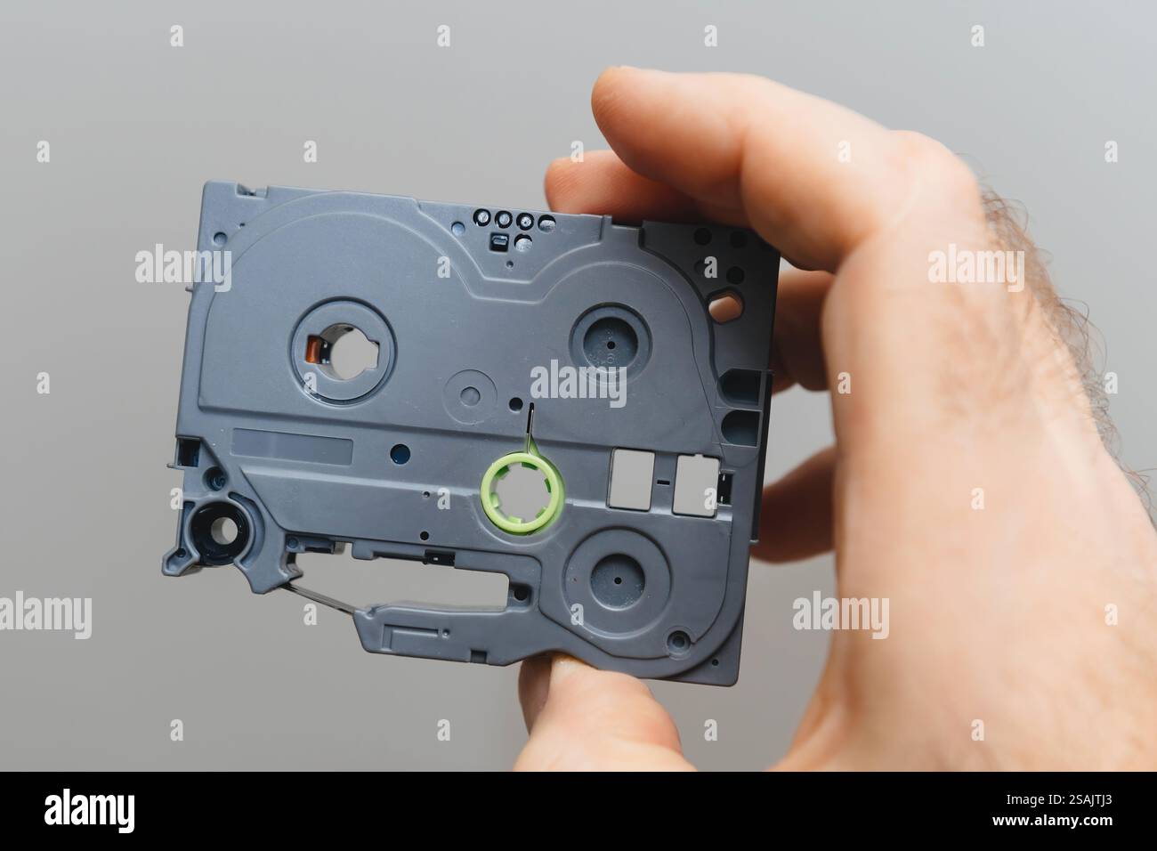 Close-up of a handheld printer labeler tape cartridge, showcasing the ...