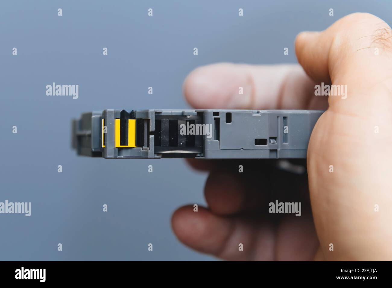 Side profile of a handheld printer labeler tape cartridge, displaying ...