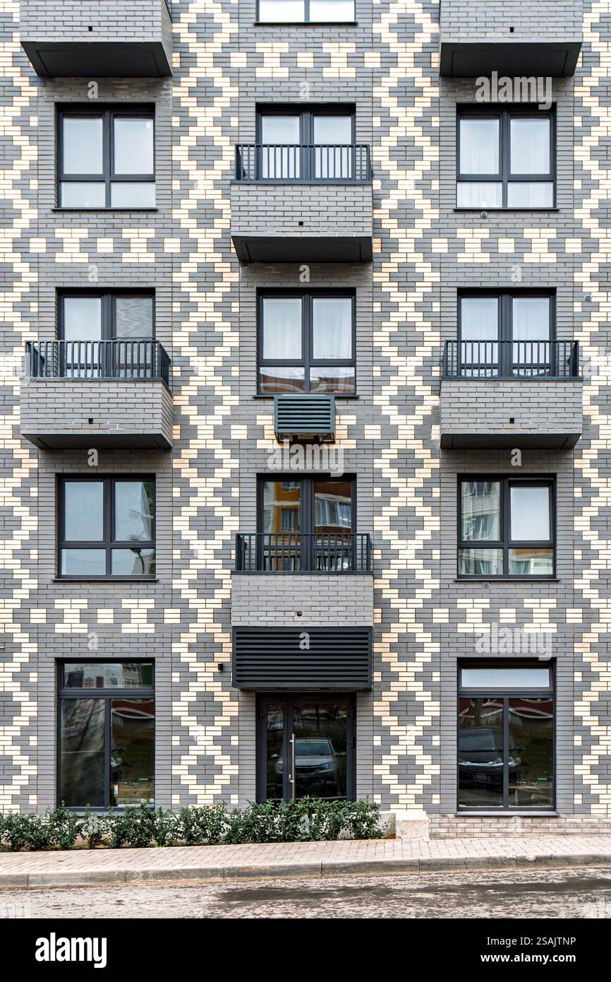 Modern building with a geometric brick pattern, featuring balconies ...