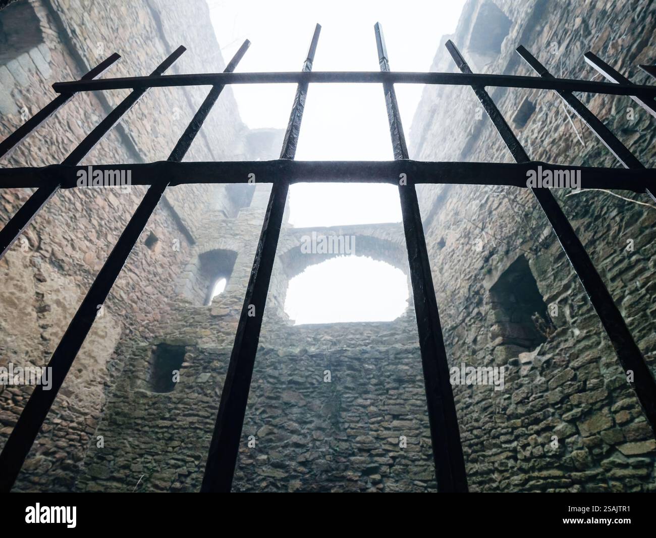 View of crumbling stone walls and arched openings of a ruined castle ...
