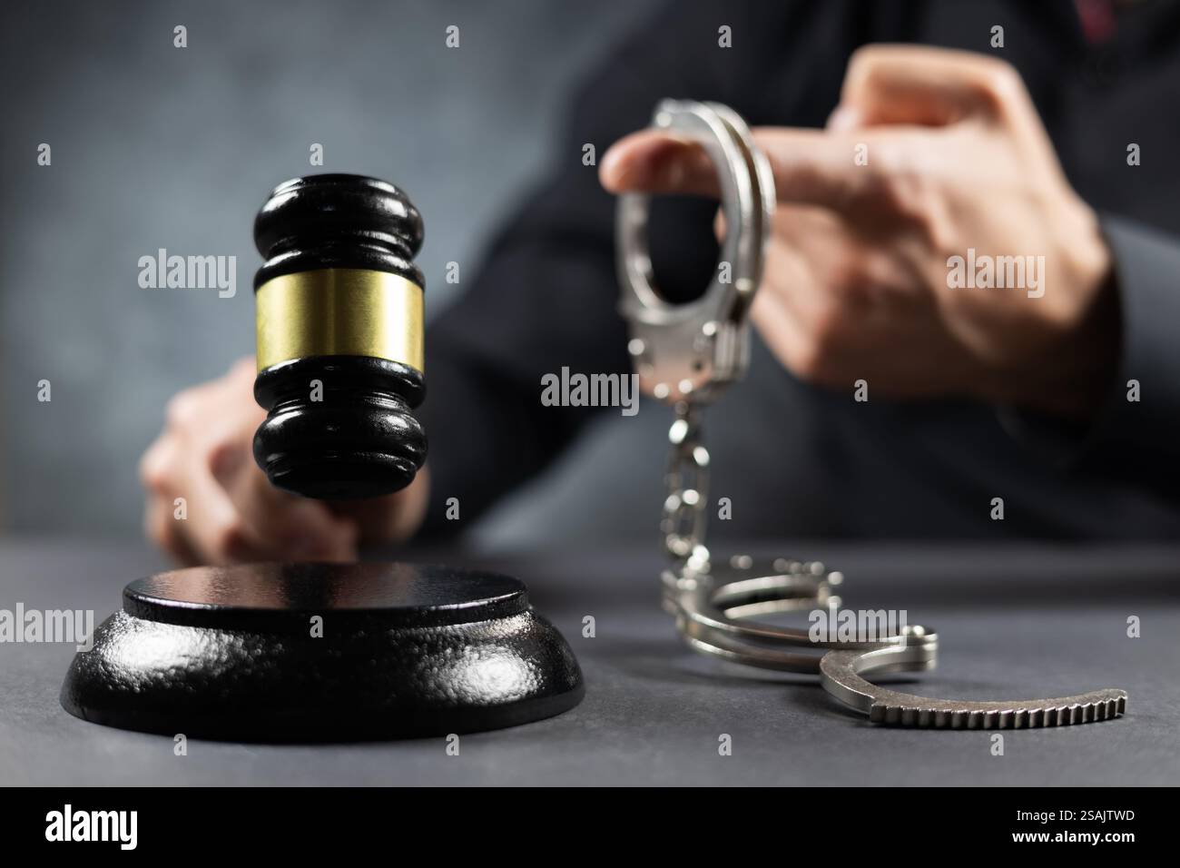 The judge with the gavel announces the verdict and shows the handcuffs ...
