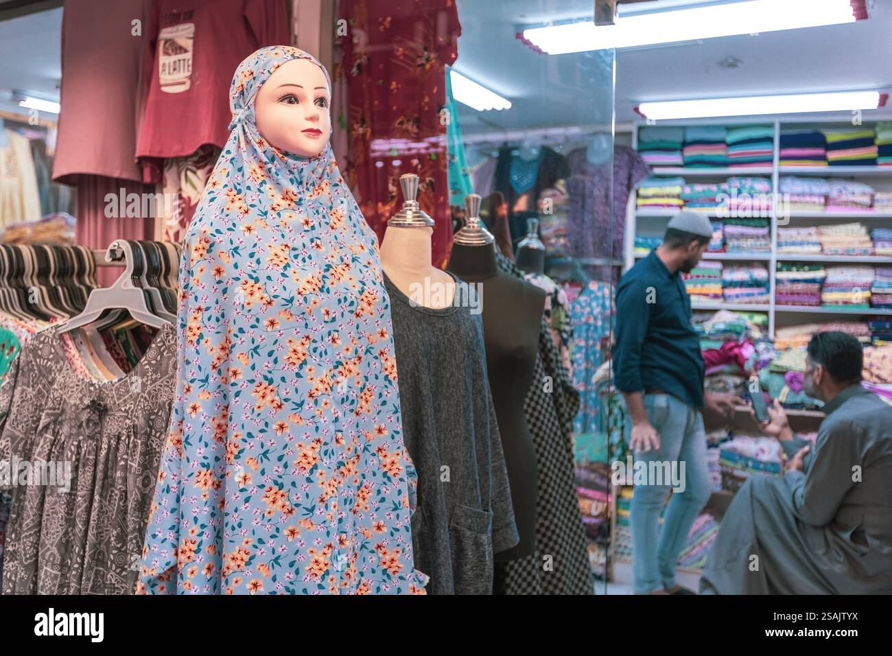 Traditional woman's muslim clothes store on the market in Manama ...