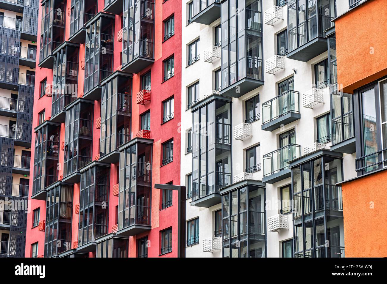 Contemporary apartment buildings with orange, white, and red facades ...