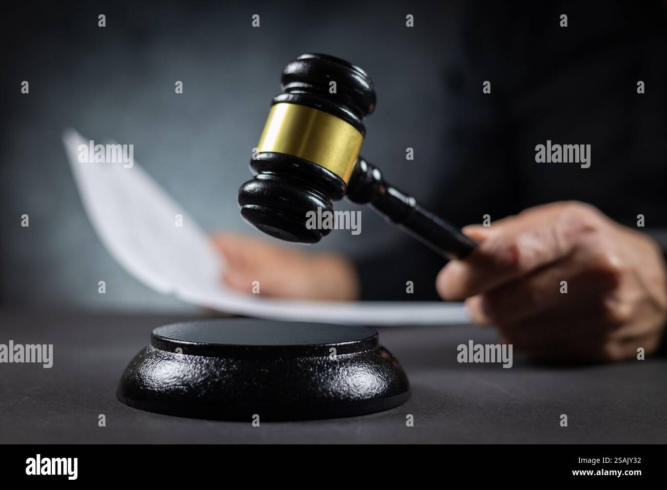 Judge with paper document pronouncing sentence in a court of law. Judge ...