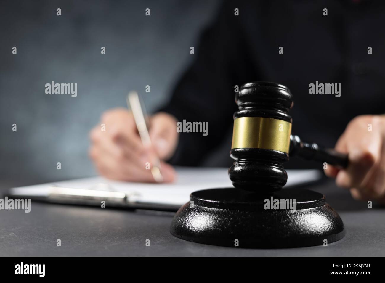 judge's gavel in hand judges is placed on a table in the legal counsel ...