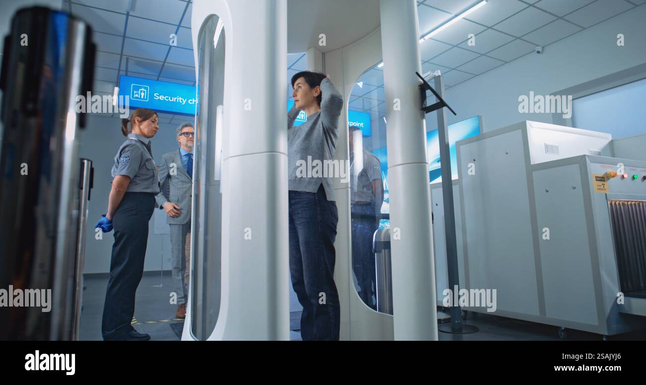 Diverse People Passing Through Metal Detector Gates in Airport Terminal ...