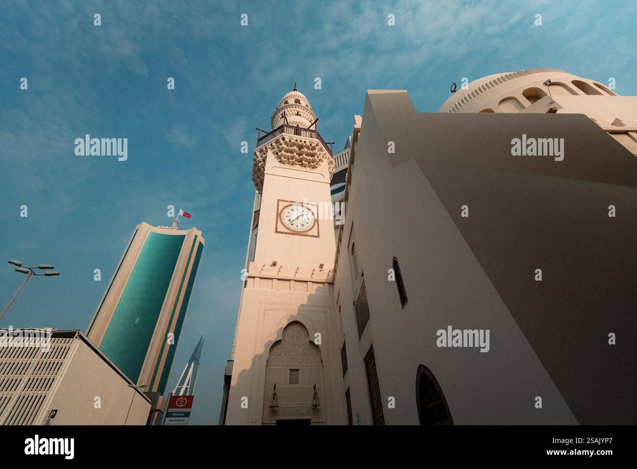 Abdulla Ali Yateem Mosque square minaret with four clocks and decorate ...