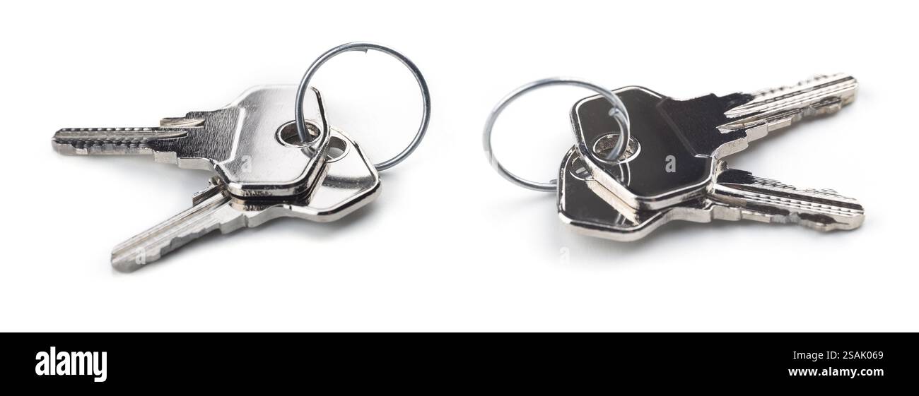 Doors keys isolated on white background. Two keys on metal keyring ...