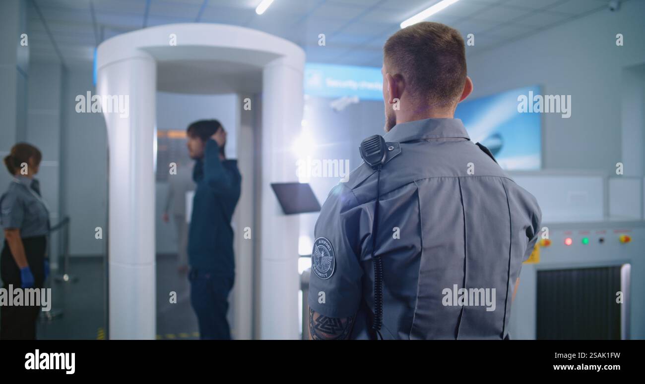 Airport Terminal: Man Walks Through Metal Detector Gates on Security ...