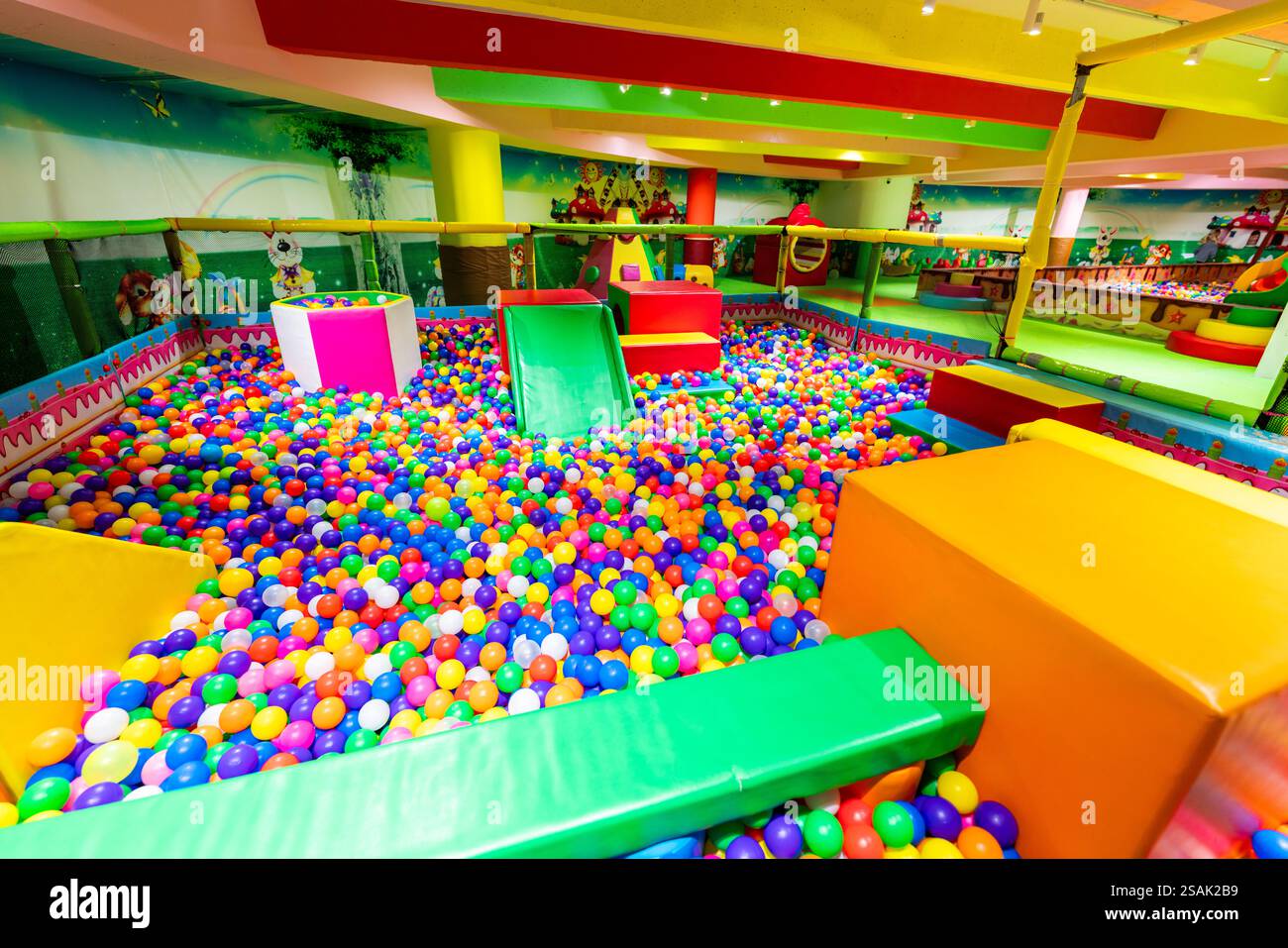 A spacious indoor playground with a colorful ball pit and soft play ...