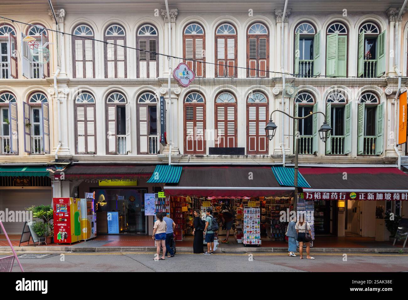 Street in scene in Chinatown where locals and tourists mingle around ...