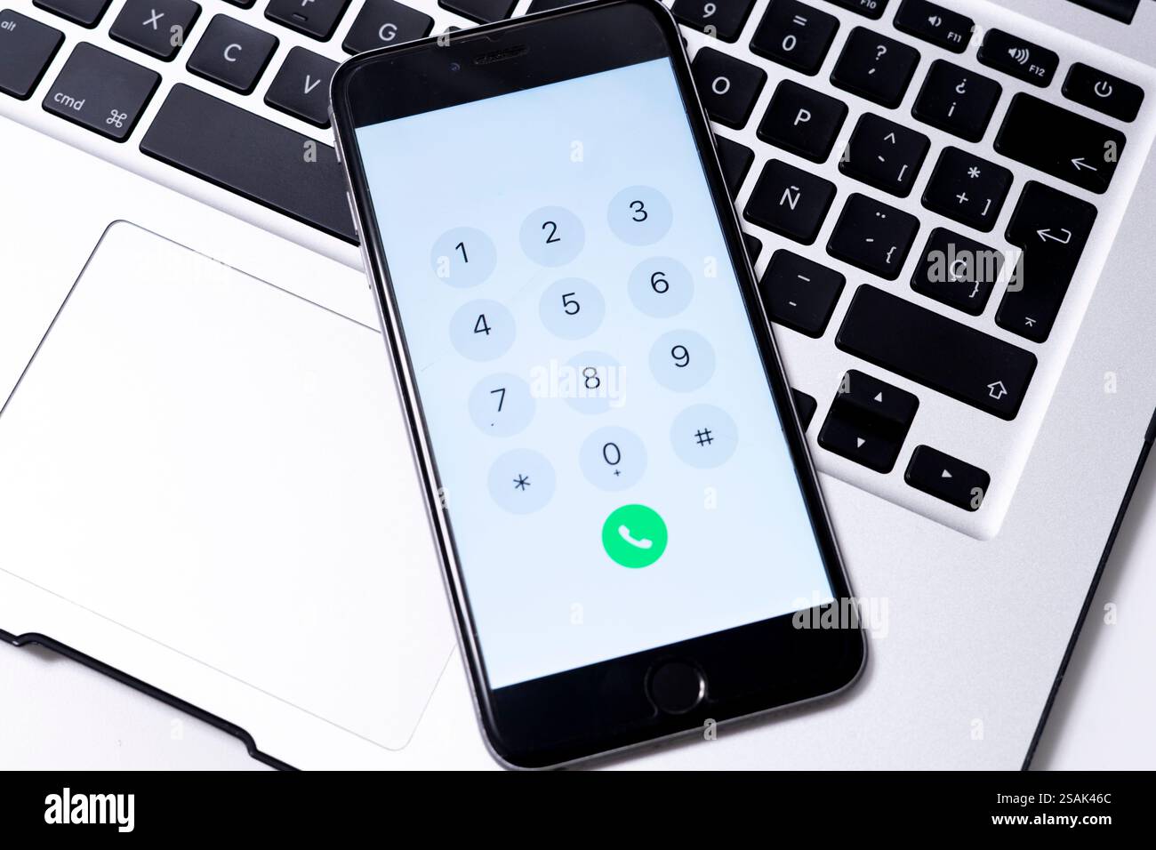 Laptop and smartphone on white background. View from above. The phone ...