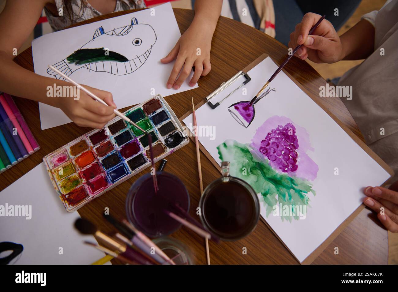 Two children engage in expressive creativity by painting vibrant ...