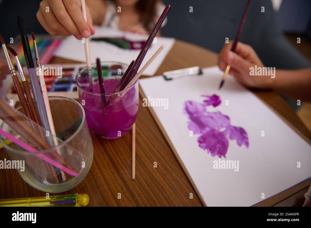 Creative artistic activity involving watercolor painting on paper ...