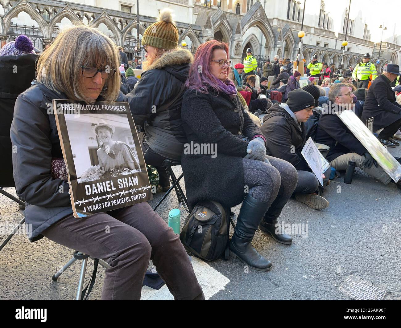 Campaigners stage a sit-down protest outside the Royal Courts of ...