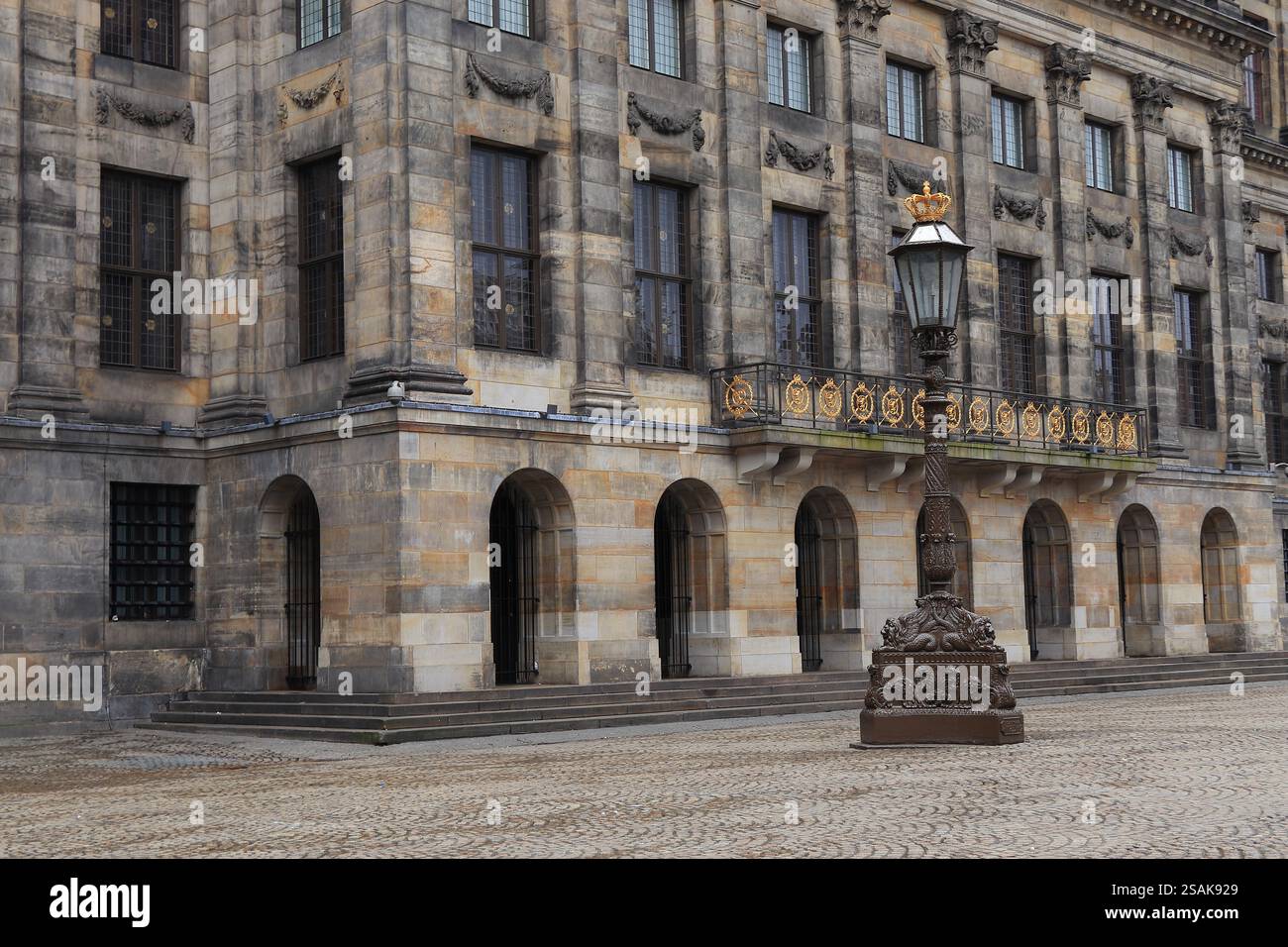 Amsterdam Dam square view with Royal Palace facade and historic lamp ...