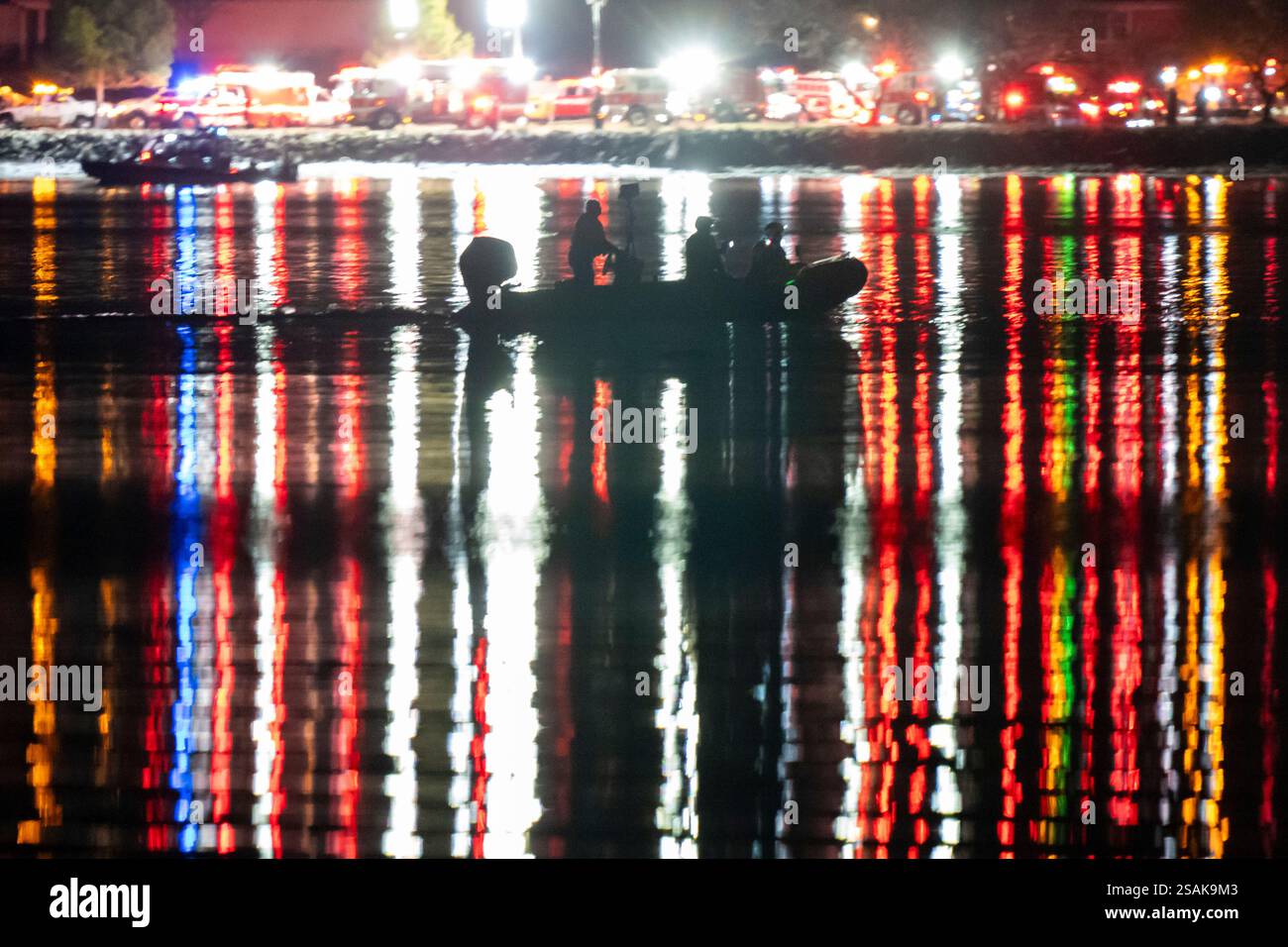 Boats work the scene of an aircraft collision near Ronald Reagan ...