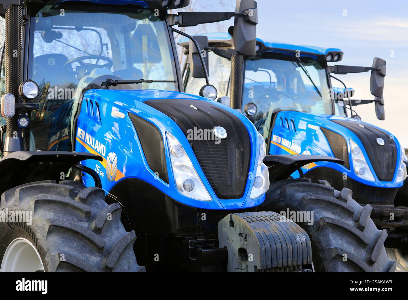 Two New Holland all-purpose tractors, left in focus T6.180 and right T6 ...